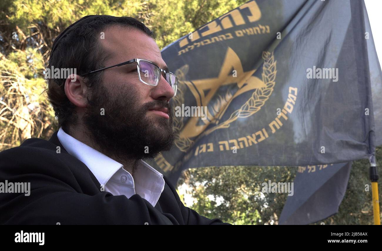 JERUSALEM, ISRAEL - JUNE 02: A religious Jew stands with the flag of ...
