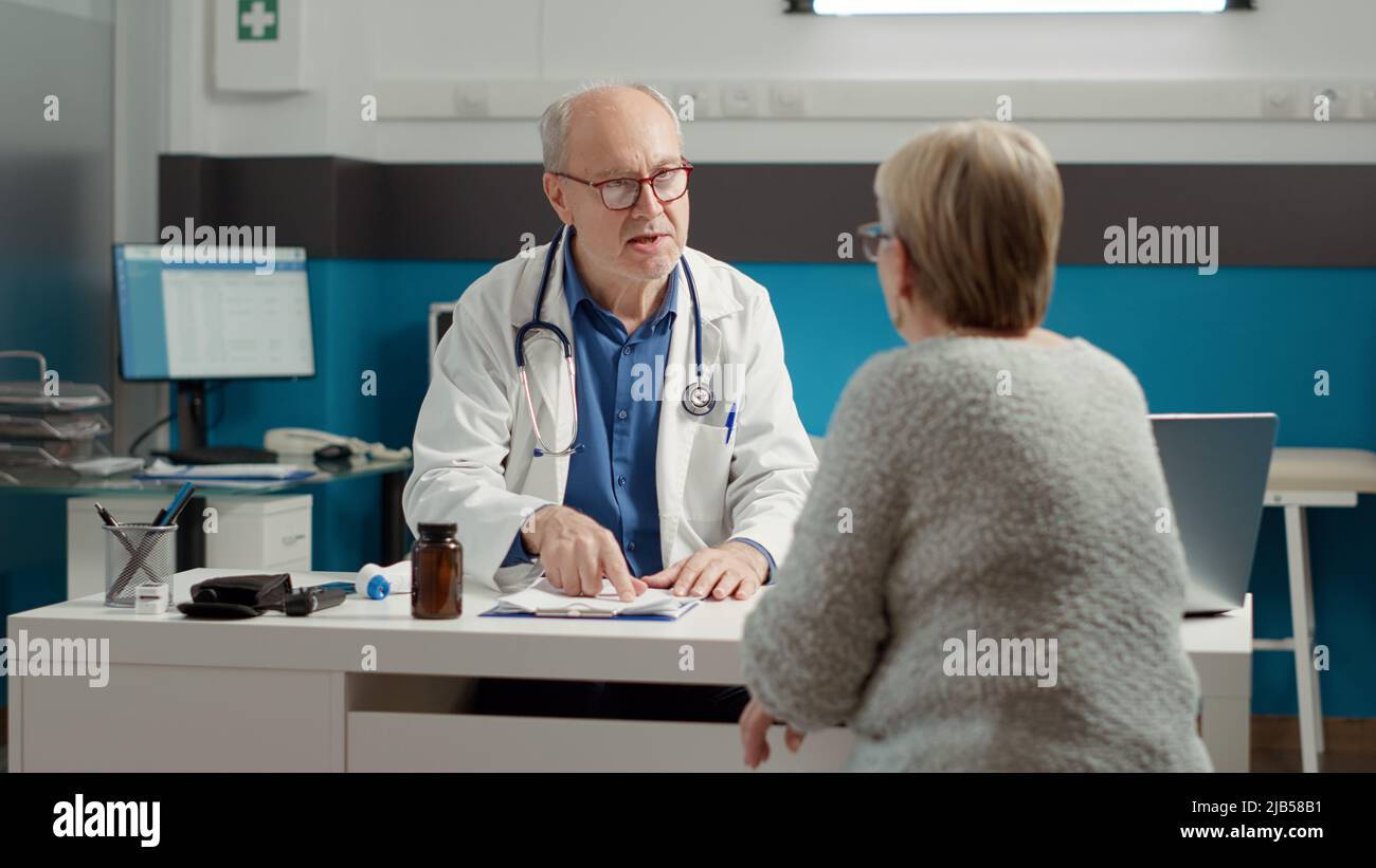 Senior physician doing checkup consultation with retired sick patient ...