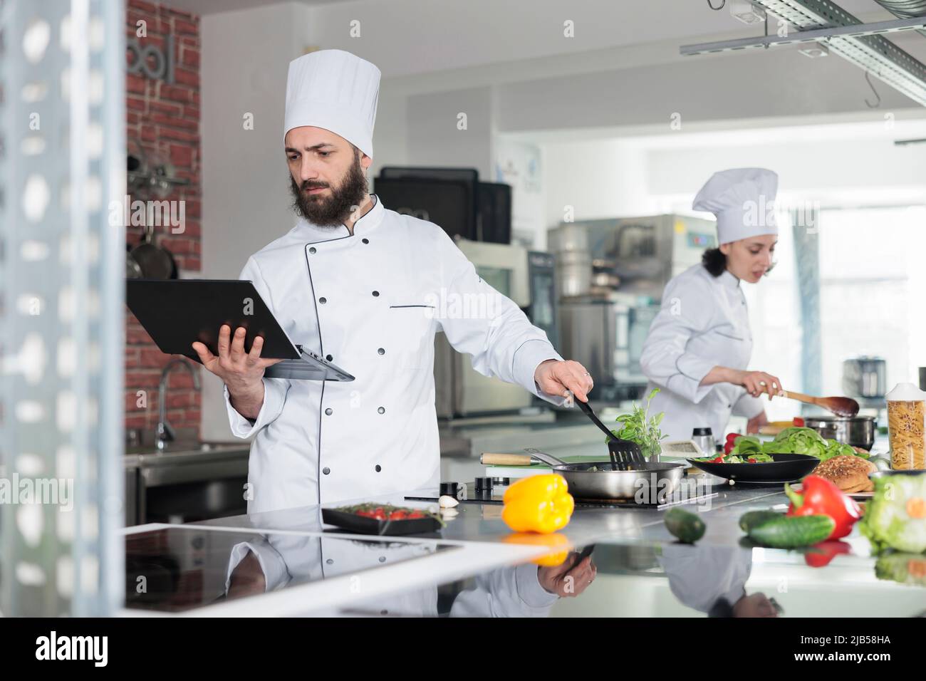 Gastronomic expert preparing dish garnish using fresh organic ...