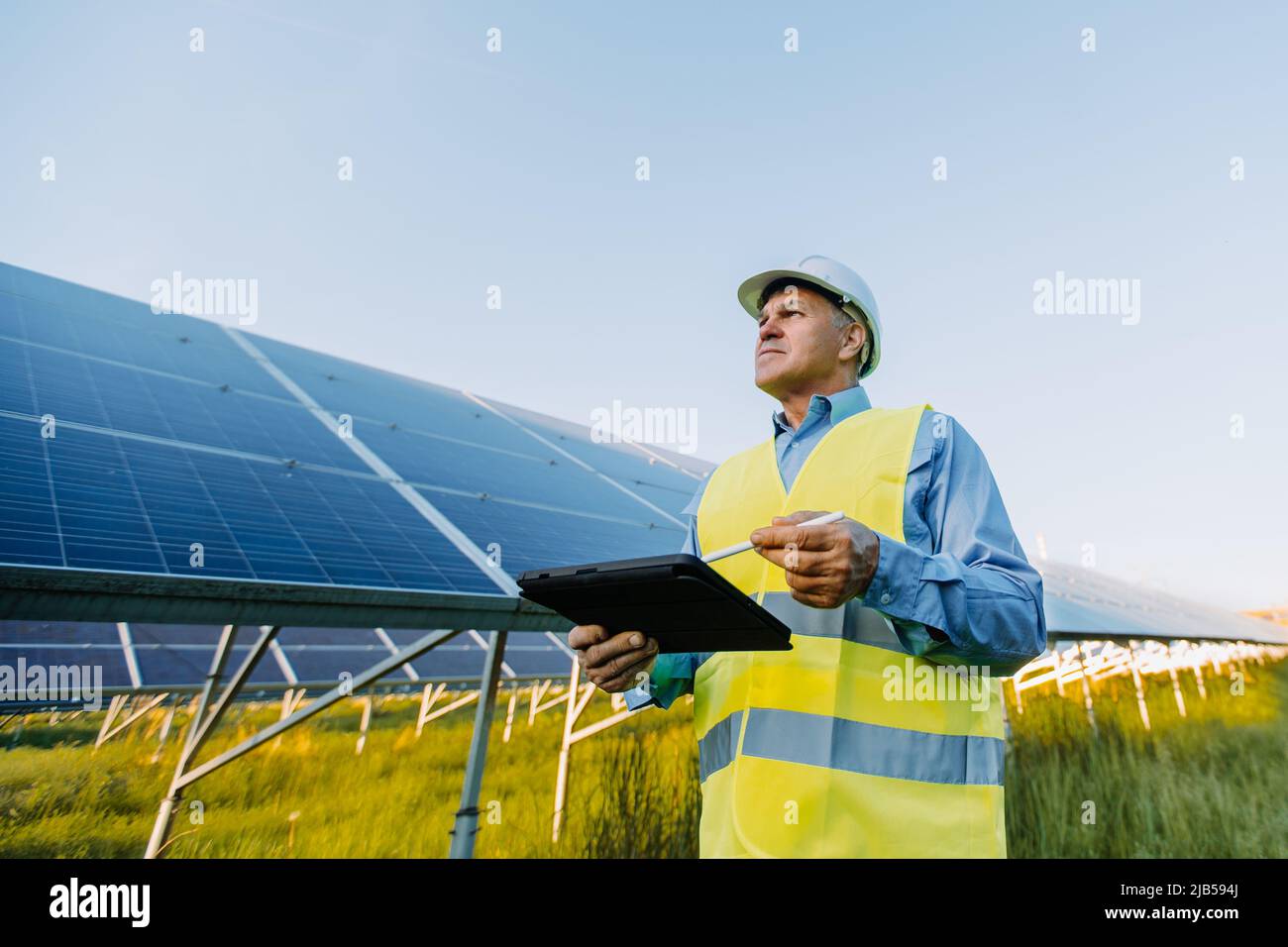 Engineer man working at alternative energy farm. Alternative eco energy ...