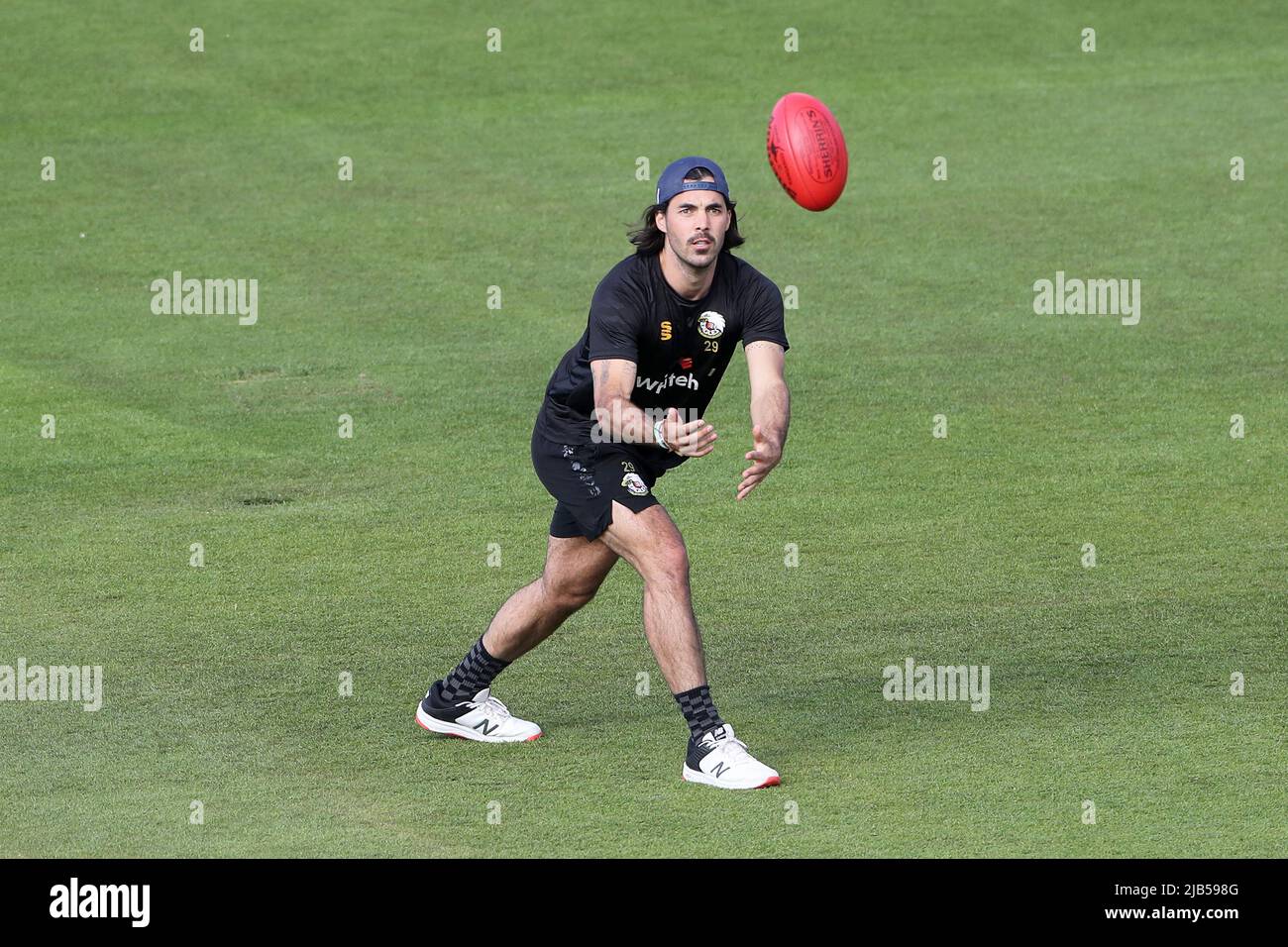 Shane Snater of Essex warms up with an Australian Rules ball during ...