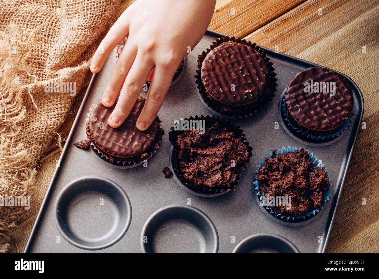 homemade chocolate cupcakes in cupcake mold on the table in the kitchen ...