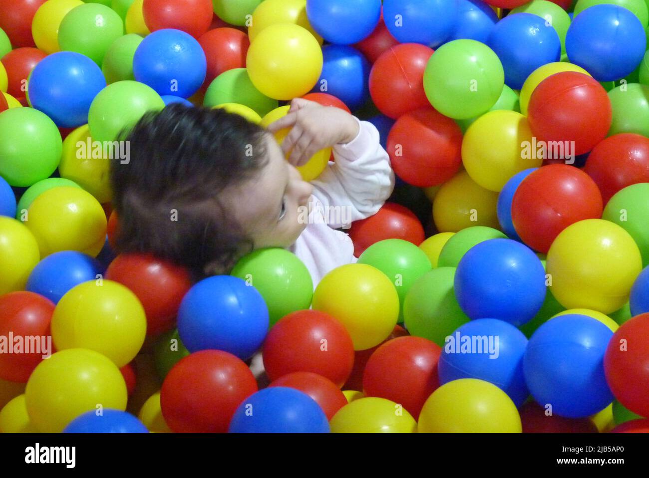 Children play with small balls hi-res stock photography and images - Alamy
