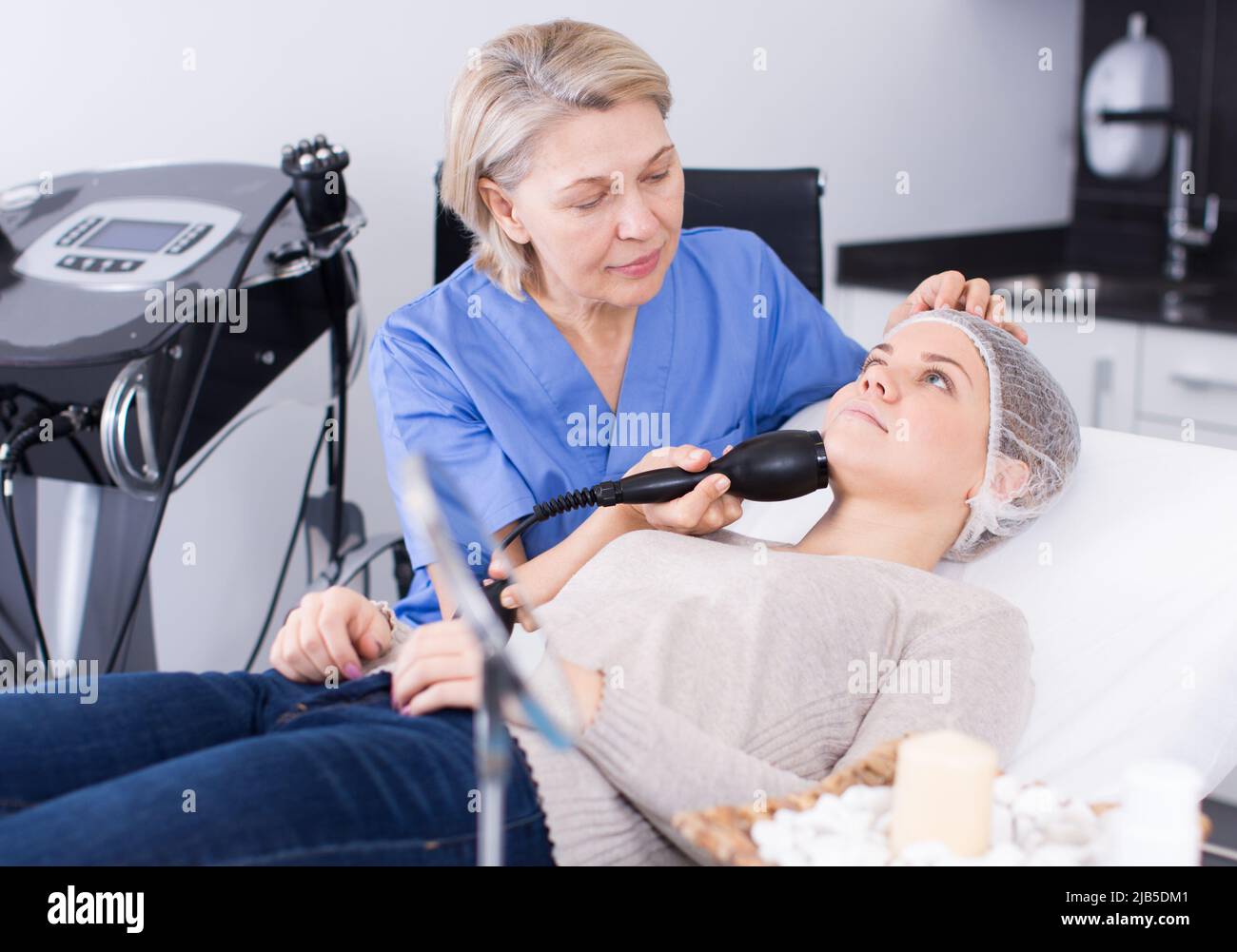 Cosmetician performing hardware face treatment Stock Photo - Alamy