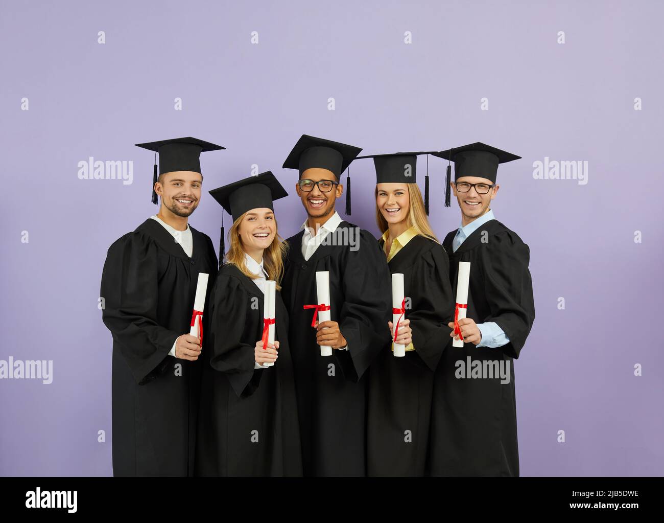 Portrait of smiling graduates with diplomas celebrate graduation Stock ...