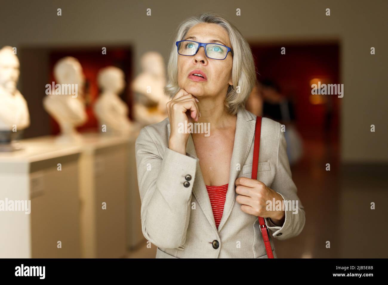 Mature woman visiting museum Stock Photo - Alamy