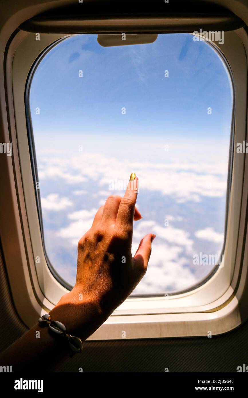 Female hand Airplane flight. View from the window of the plane ...