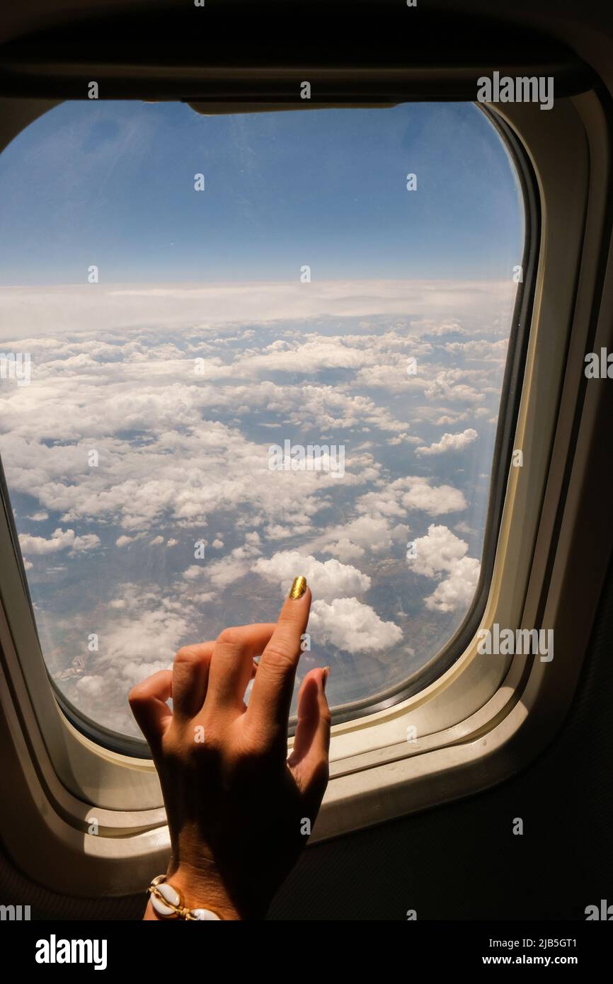 Female hand Airplane flight. View from the window of the plane ...