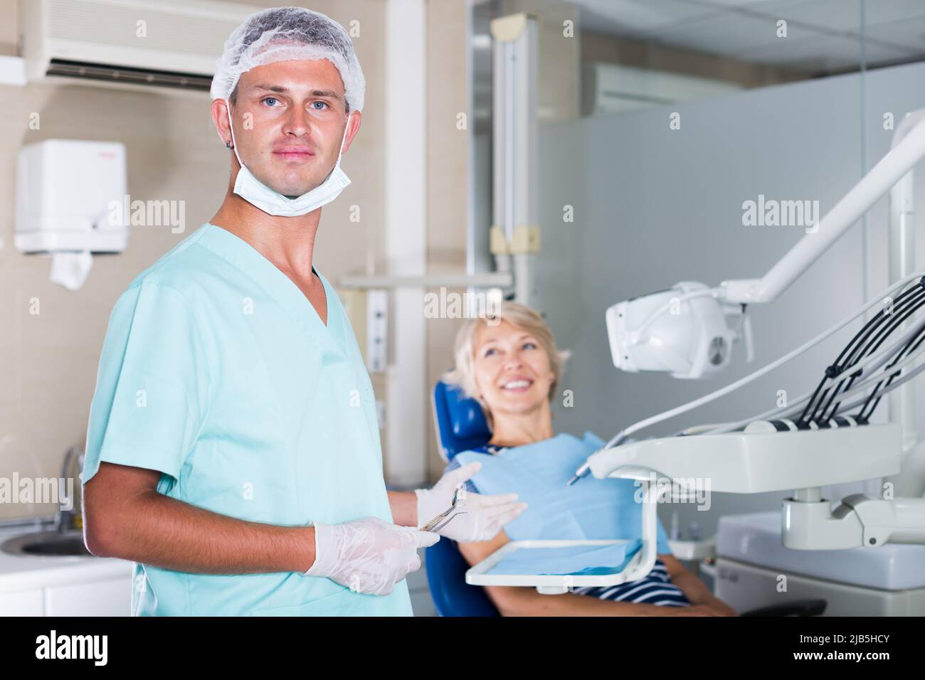 Male dentist standing in dental office Stock Photo - Alamy