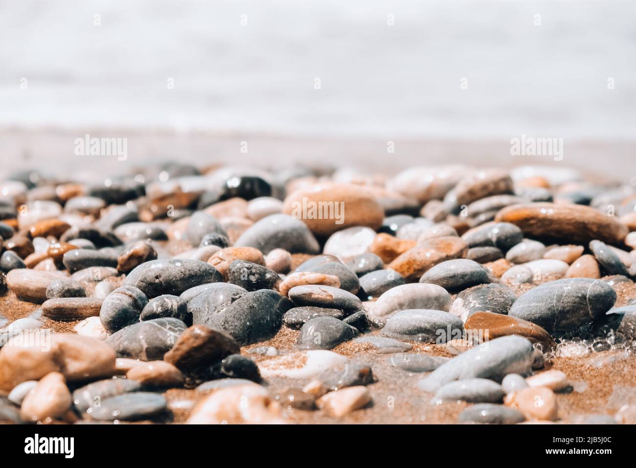 Rock balancing on ocean beach. Pyramid of pebbles on sandy shore ...