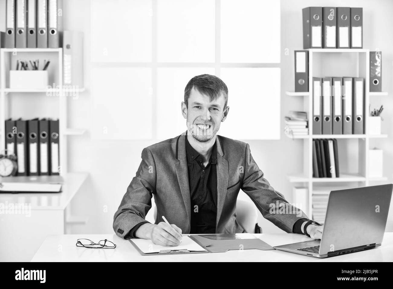 client is First. male manager work on laptop. Busy man in modern ...