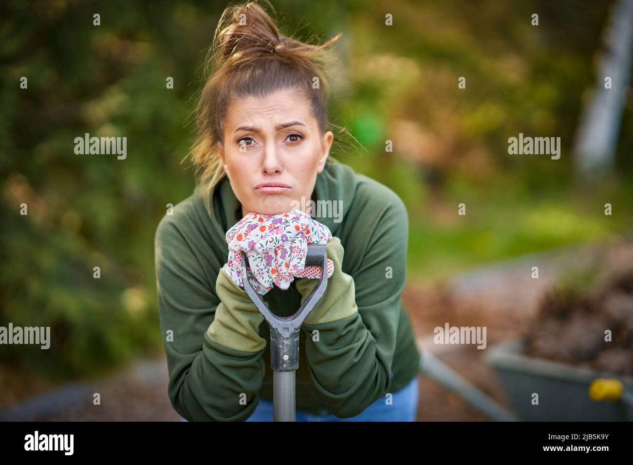 Picture of tired woman working with tools in the garden Stock Photo - Alamy