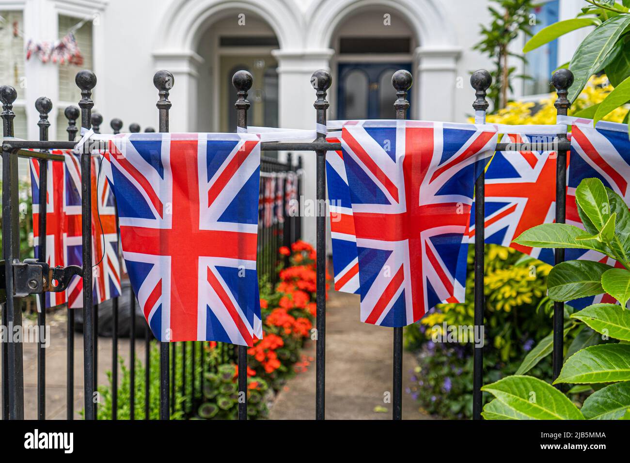 3 June 2022: Union Jack bunting decoration on iron gate in Wimbledon ...