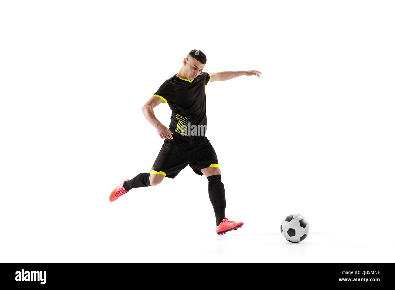 Professional male football soccer player in motion and action isolated ...