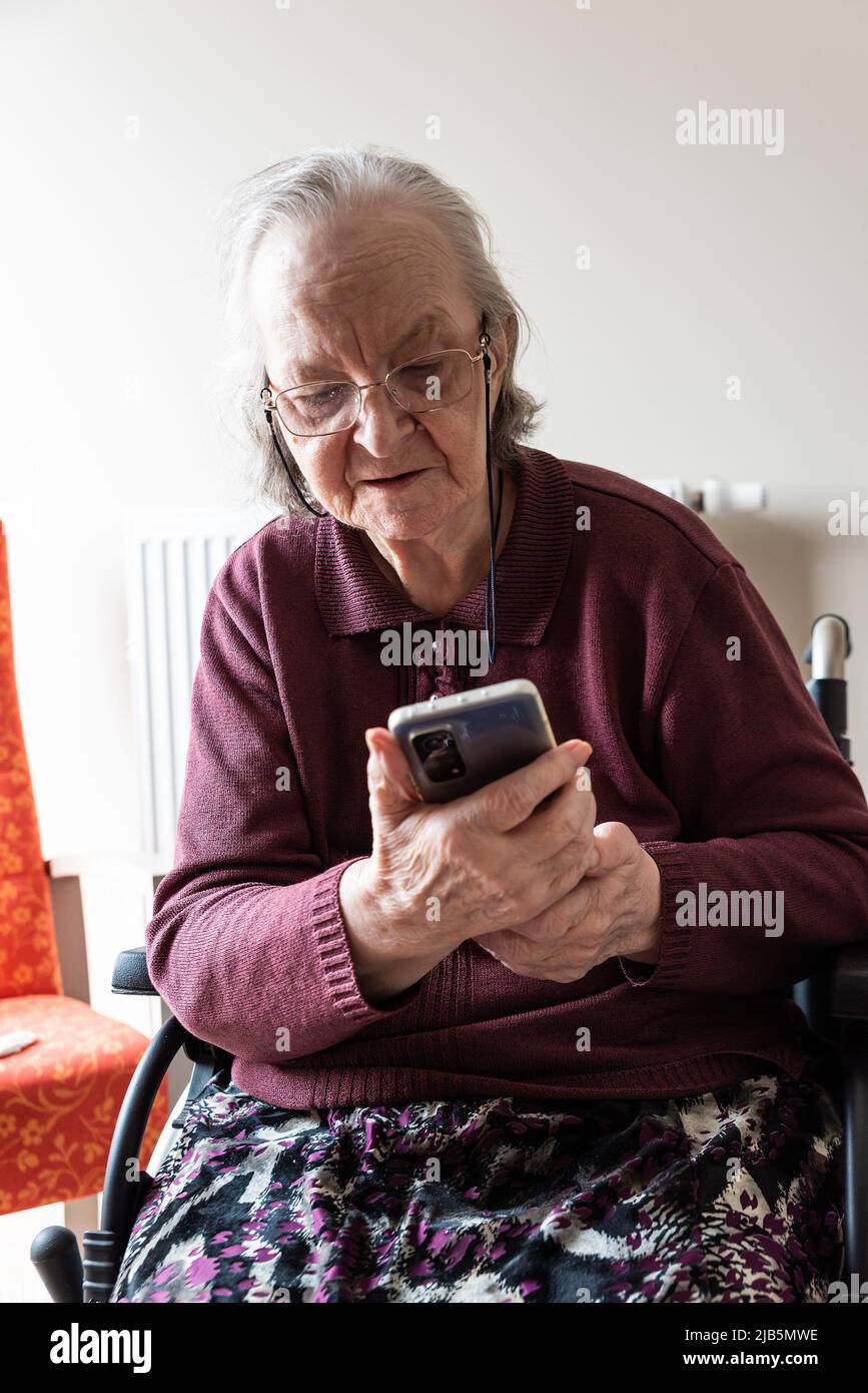 83 Year Old Grandmother Having A Video Call Sitting In A Wheelchair 83-year-old-grandmother-having-a-video-call-sitting-in-a-wheelchair