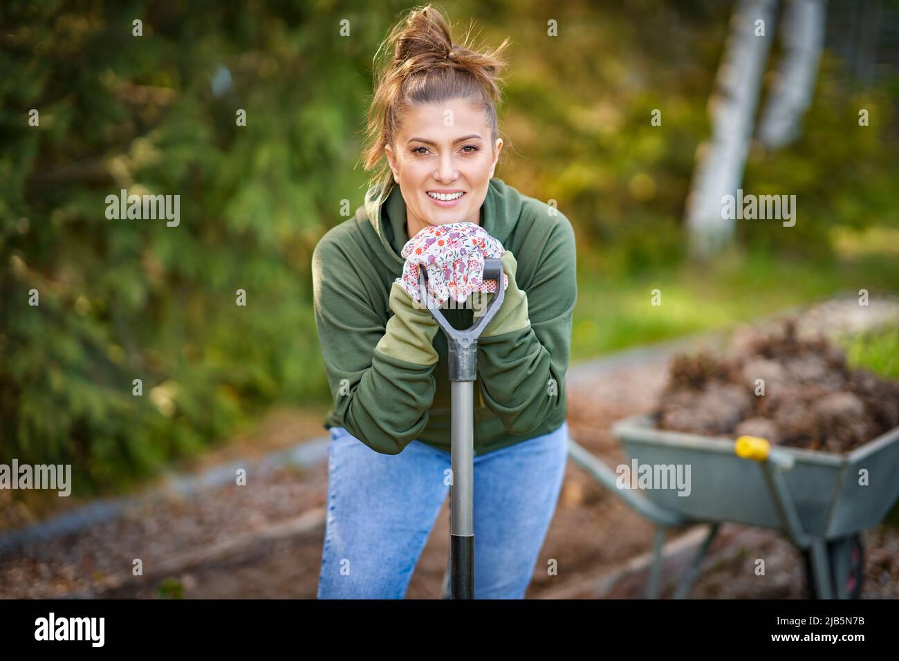 Picture of woman working with tools in the garden Stock Photo - Alamy
