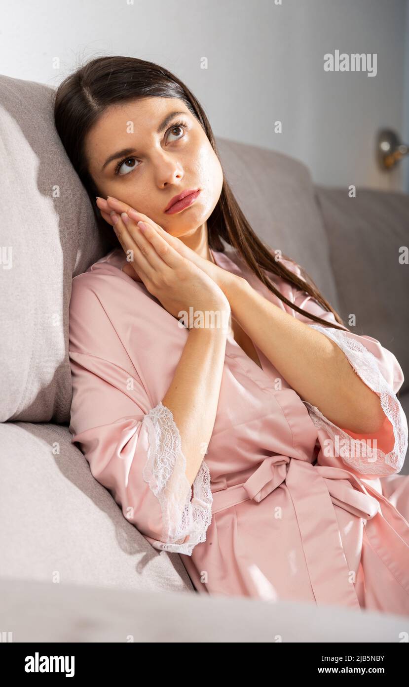 Woman is thoughtful and bored alone at home Stock Photo - Alamy
