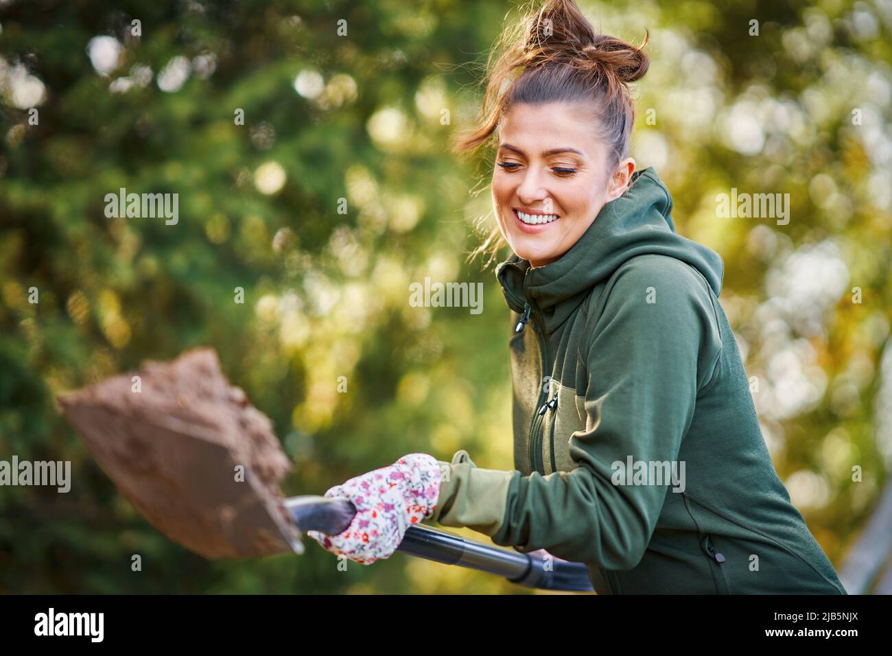 Picture of woman working with tools in the garden Stock Photo - Alamy