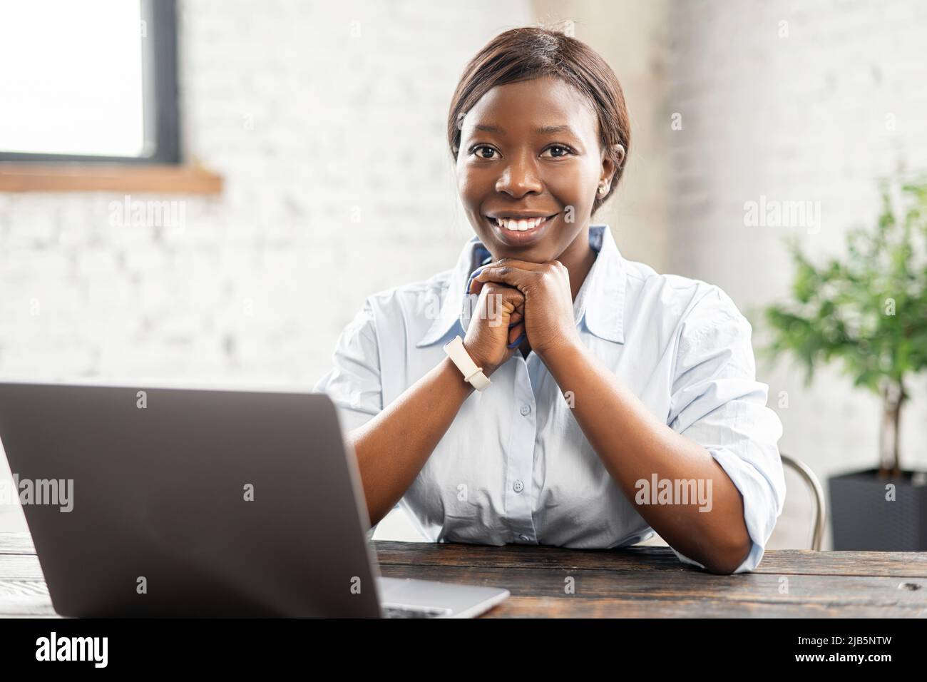 Confident Afruican-American businesswoman using laptop in the office ...