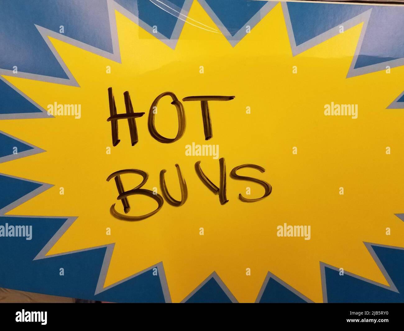 hot buys sign written on yellow and blue paper Stock Photo - Alamy