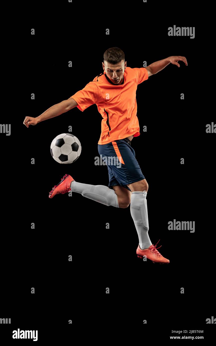 Studio shot of professional male football soccer player in motion ...