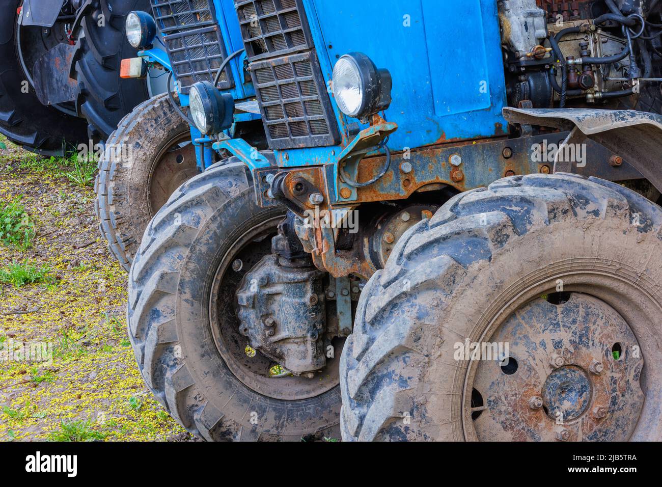 blue belarussian tractors, wheels and opened diesel engine compartment ...