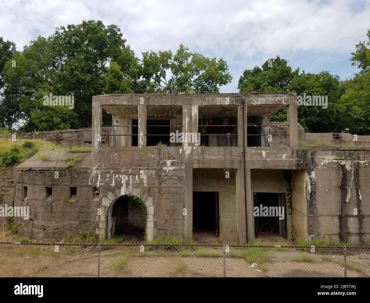 old abandoned grey cement building with weeds growing Stock Photo - Alamy
