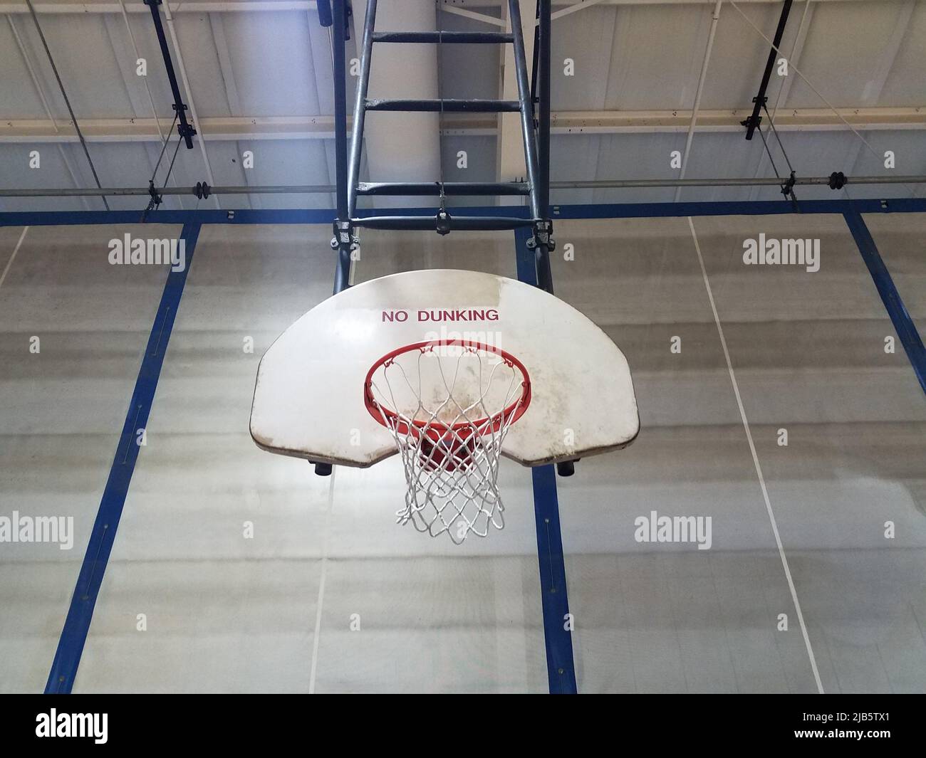 basketball hoop with backboard saying no dunking in gym Stock Photo - Alamy