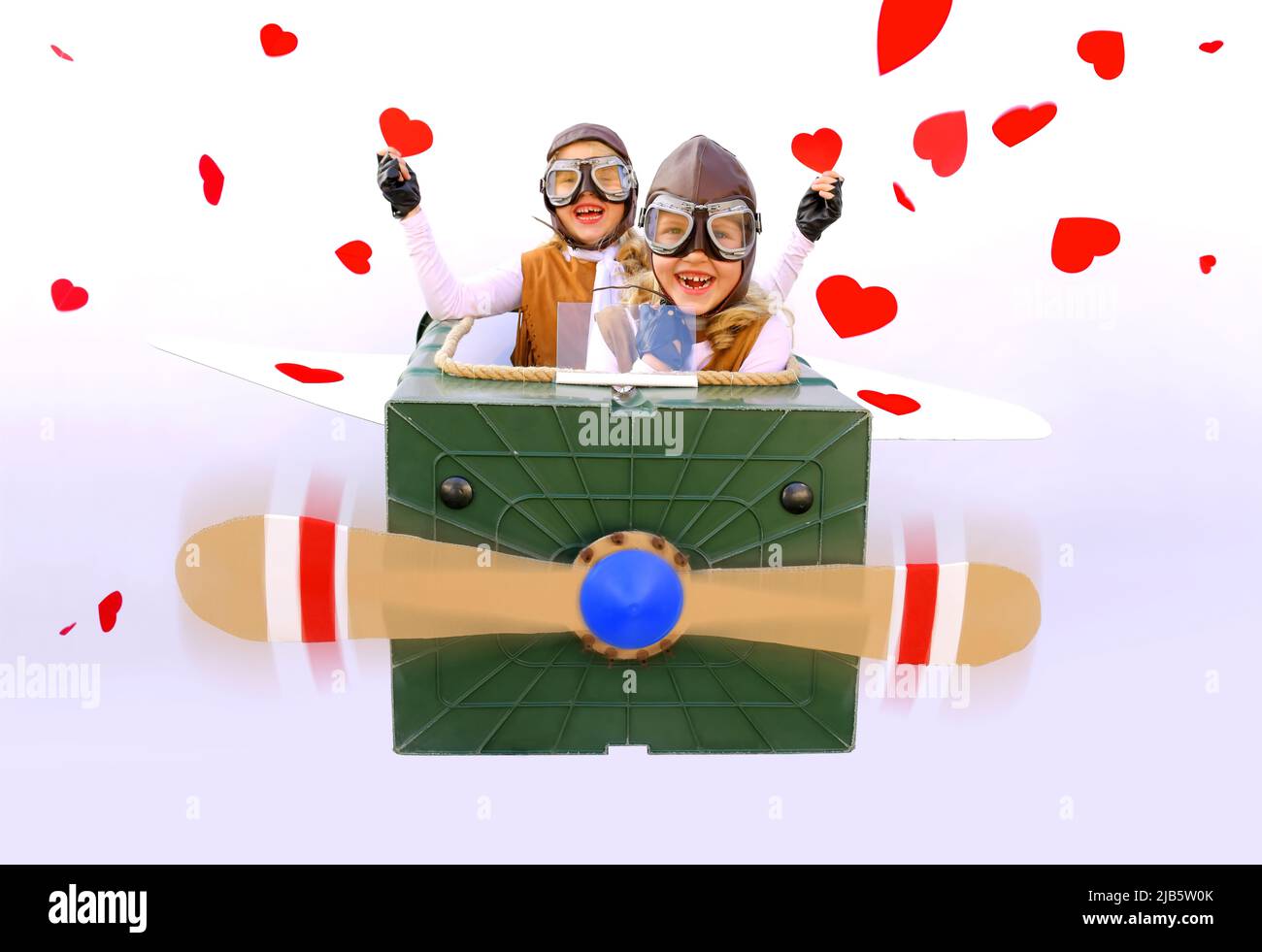 Twin sisters sit at the controls of their imaginary airplane. They are ...