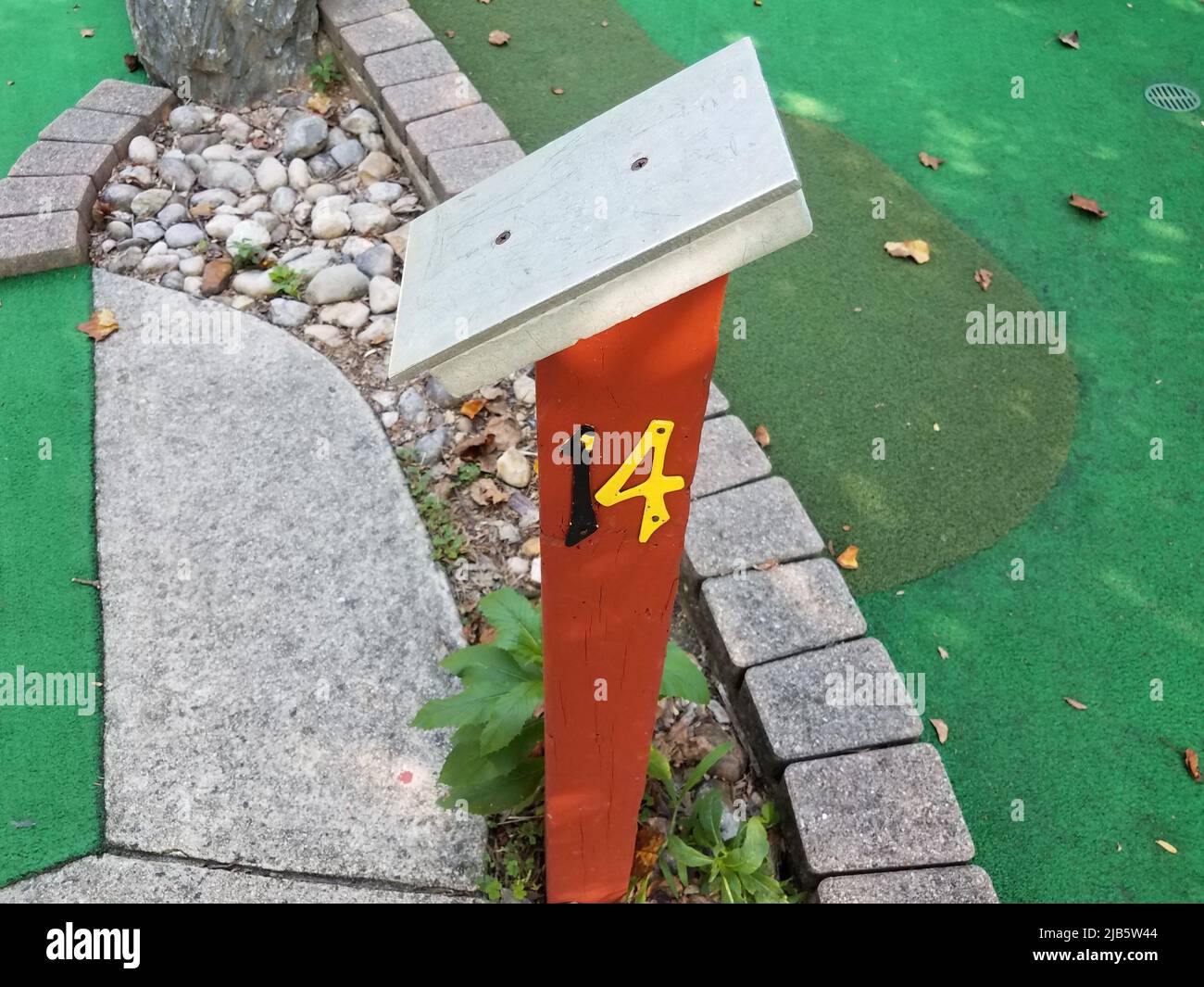 number 14 sign with writing surface on wood post on miniature golf ...