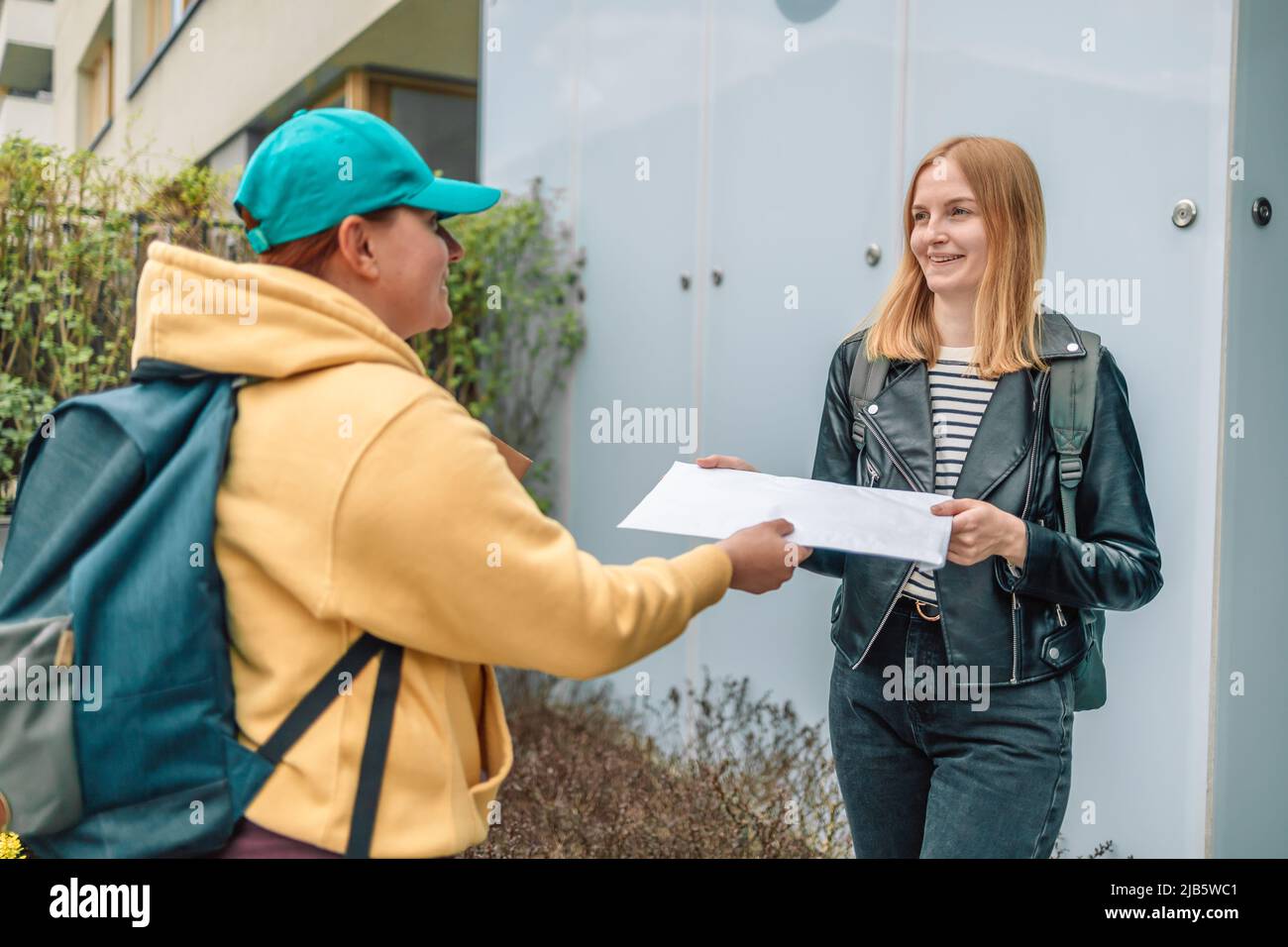 Courier service delivery woman giving paper mail letter parcel to ...