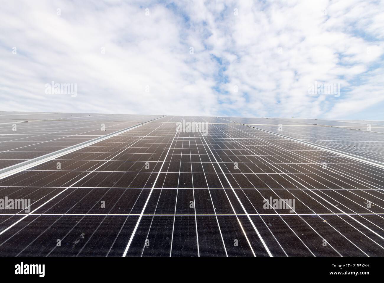 Solar park. Blue sky with clouds Stock Photo - Alamy