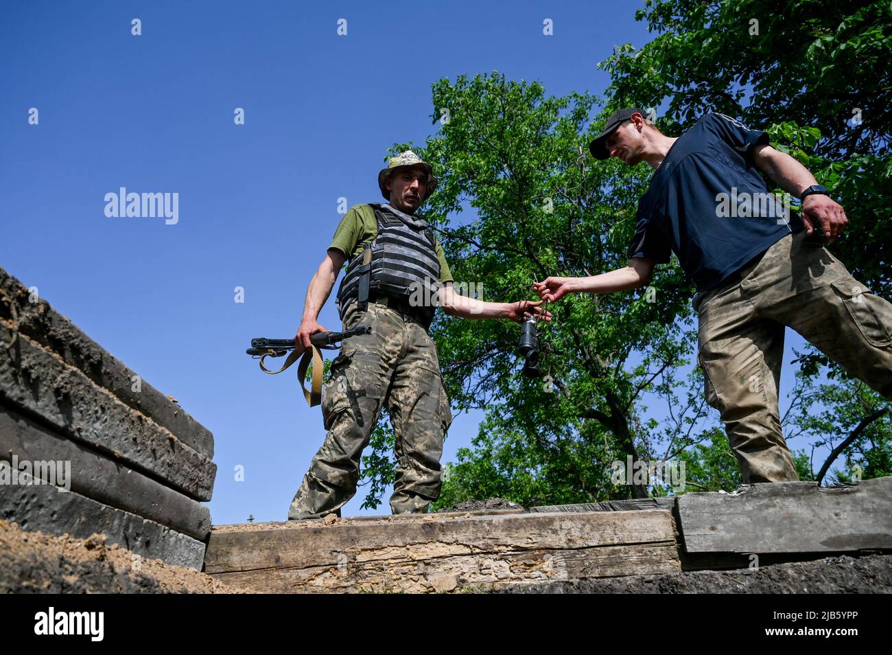Ukrainian Territorial Defence Forces servicemen stand guard at the ...