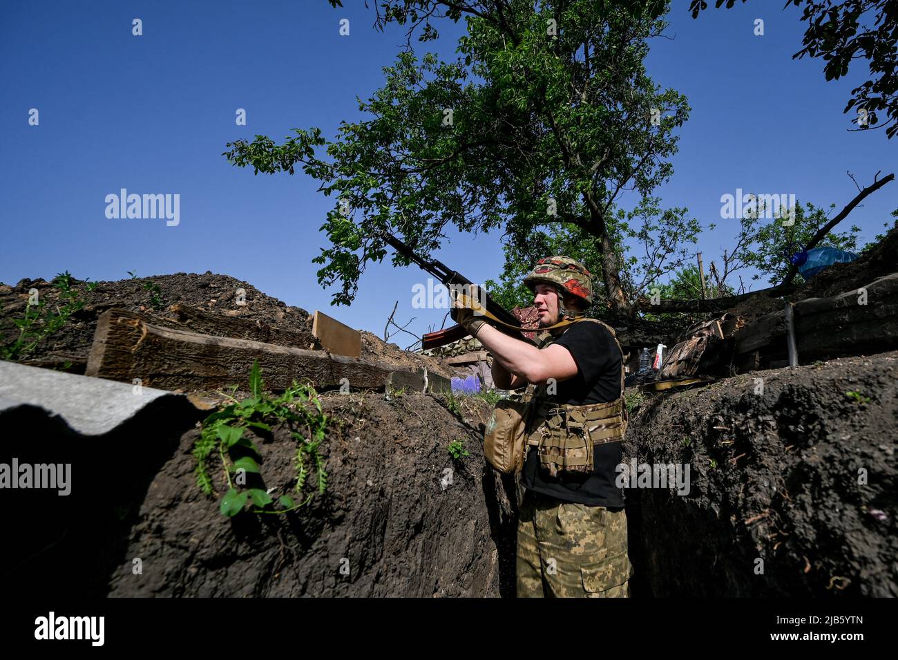 A Ukrainian Territorial Defence Forces serviceman points a rifle from a ...