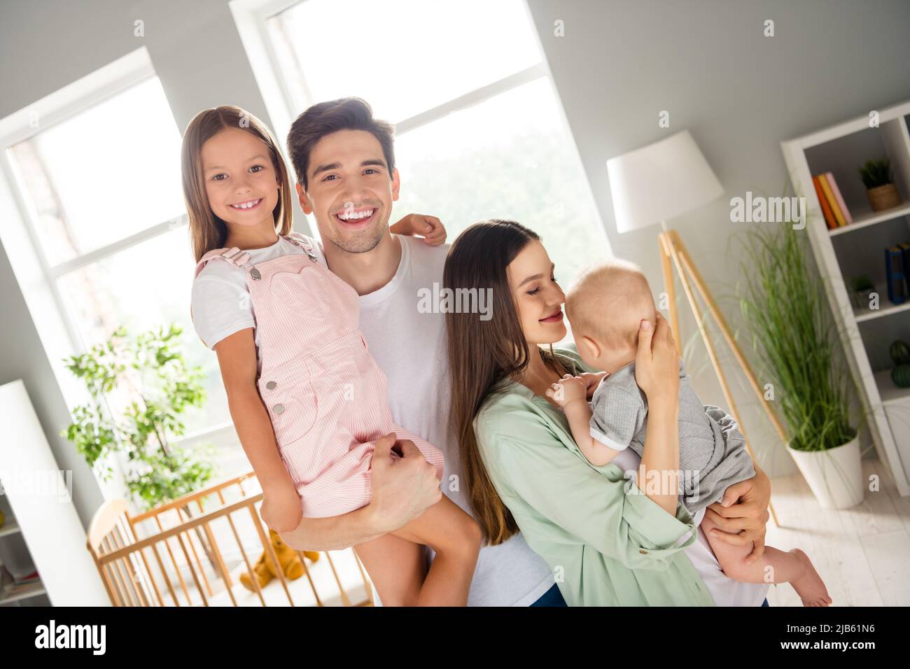 Portrait of idyllic peaceful family cuddle support each other enjoy weekend house indoors Stock ...