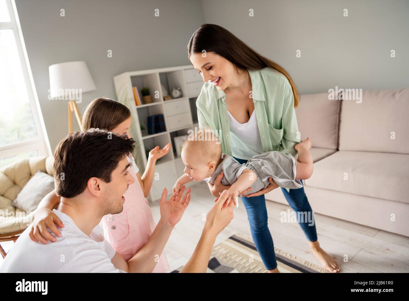 Photo of full positive cheerful family play toddler have fun together ...