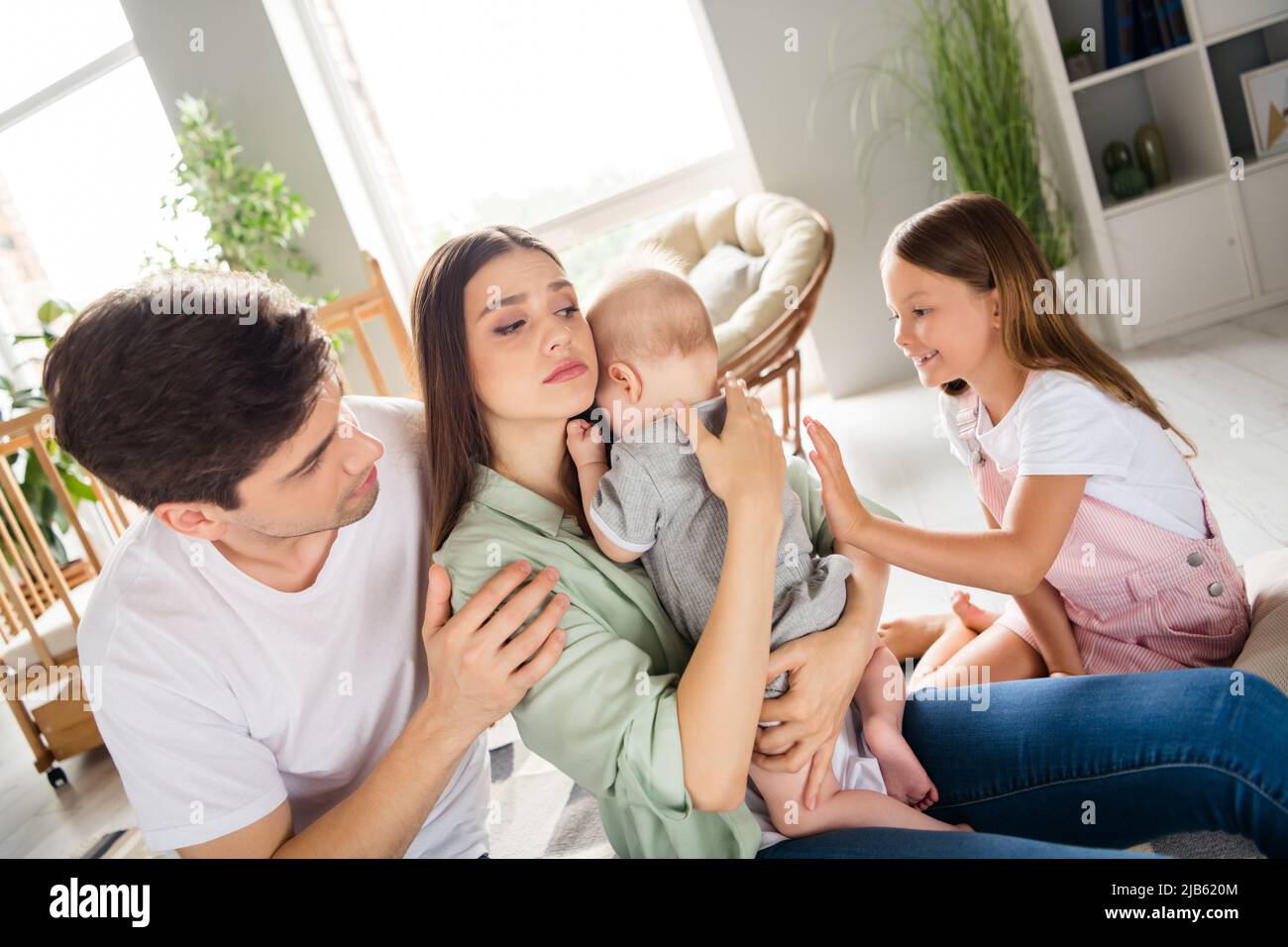 Portrait of full family parents cuddle calming toddler spend free time ...