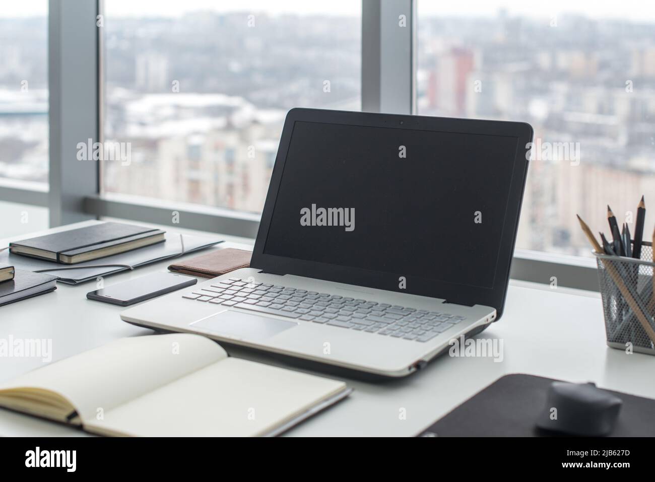 Workplace with notebook laptop Comfortable work table in office with ...