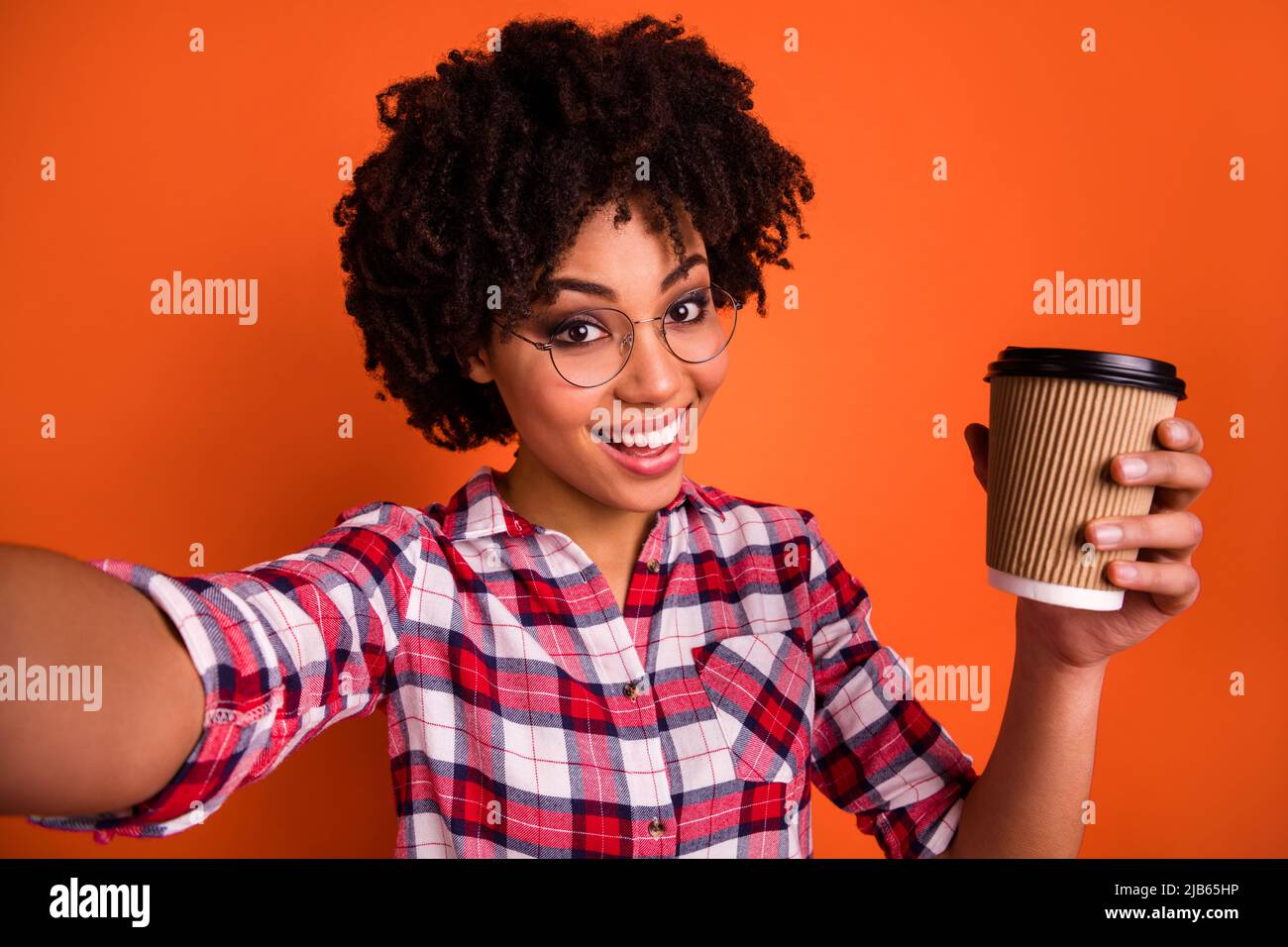Portrait of positive lady making selfie showing fresh latte takeout mug ...