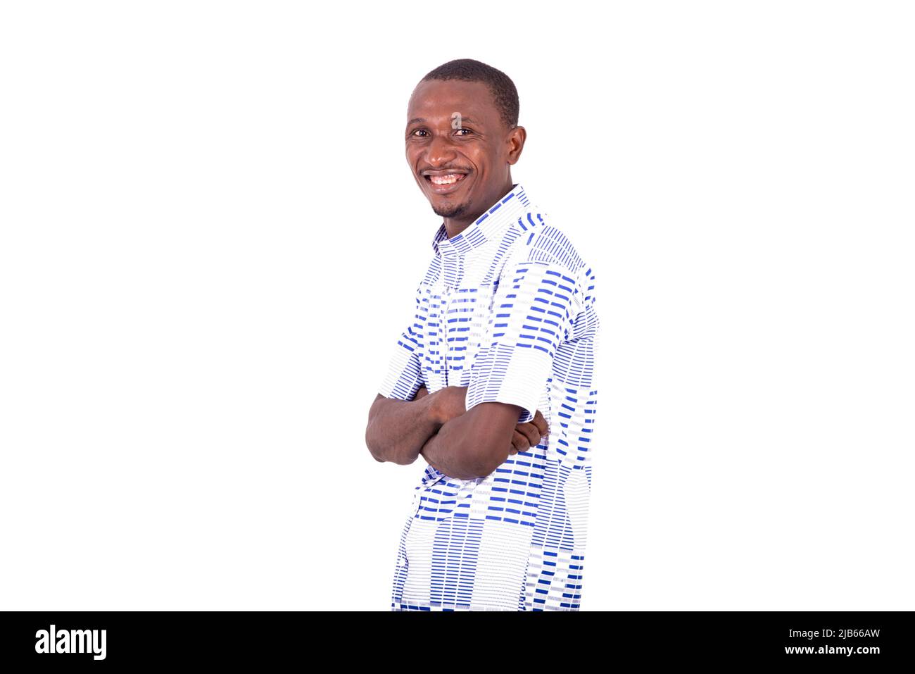happy young man standing sideways crossing his arms while smiling at ...