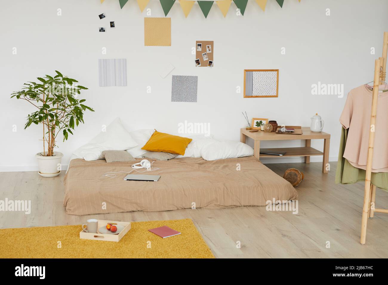 Interior of contemporary bedroom with wall decorated photographs and ...