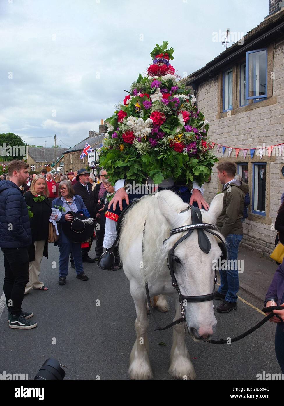 The Castleton Garland King wearing a hooped garland of flowers rides on ...