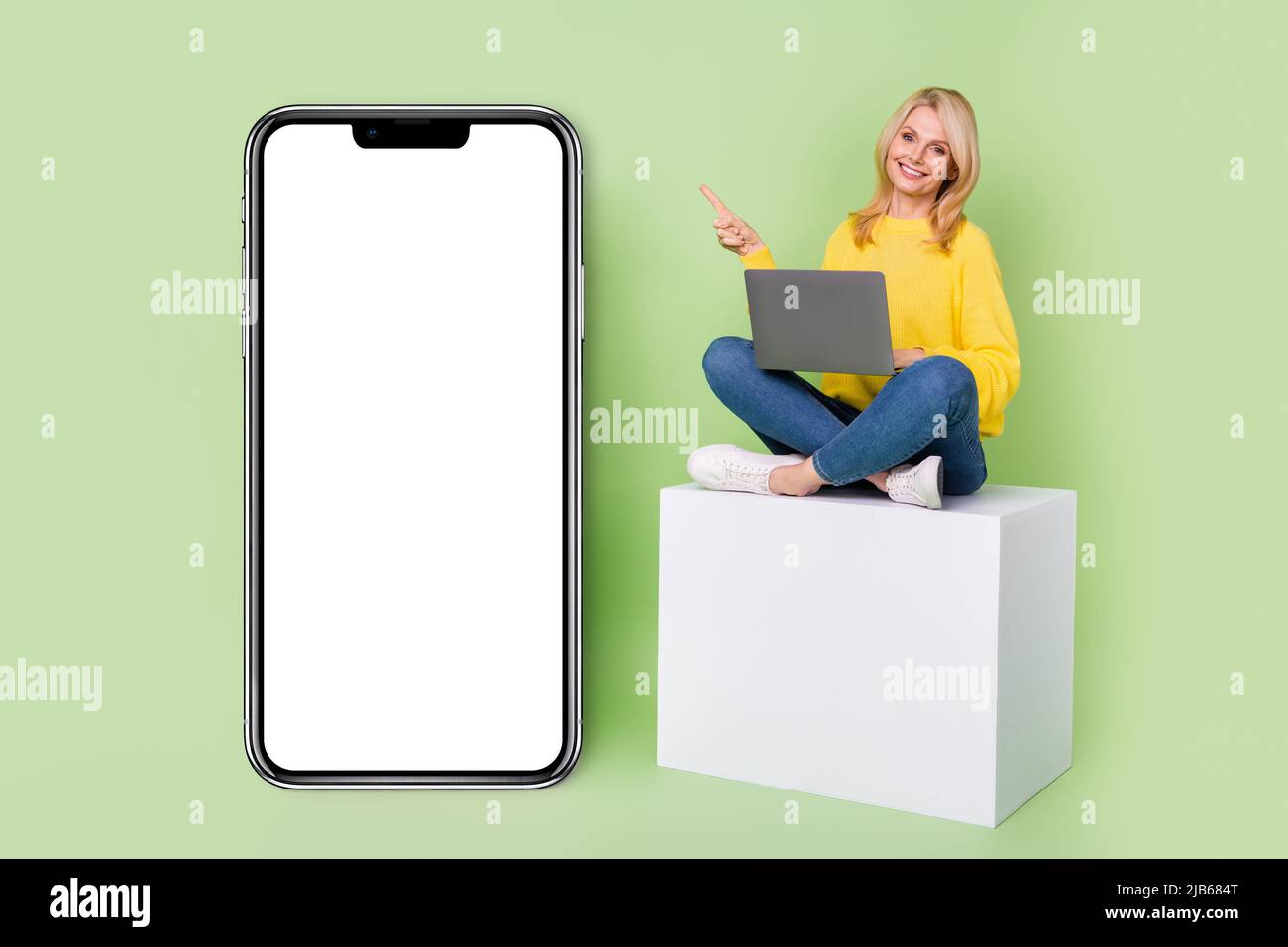 Photo of retired lady sit cube point mobile phone placard use netbook ...