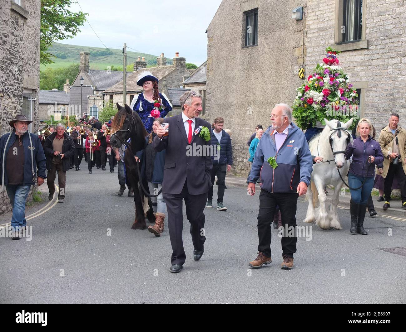 The Castleton Garland King wearing a hooped garland of flowers rides on ...