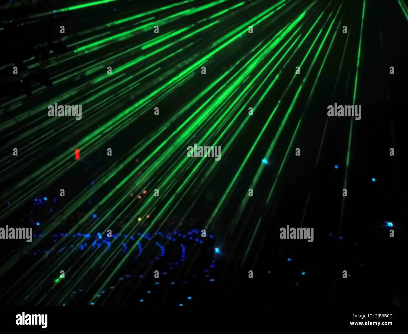 Bright beams illuminate a dark space with bright glowing lights. Laser ...