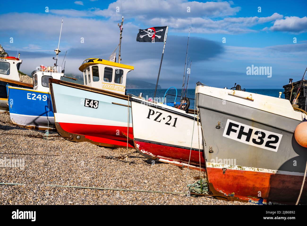Fishing boats hauled up on the the beach at Beer, Devon, UK Stock Photo ...
