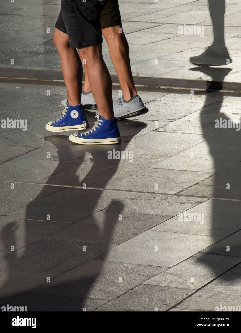 Detail of young men legs walking with sneakers in summer time Stock ...