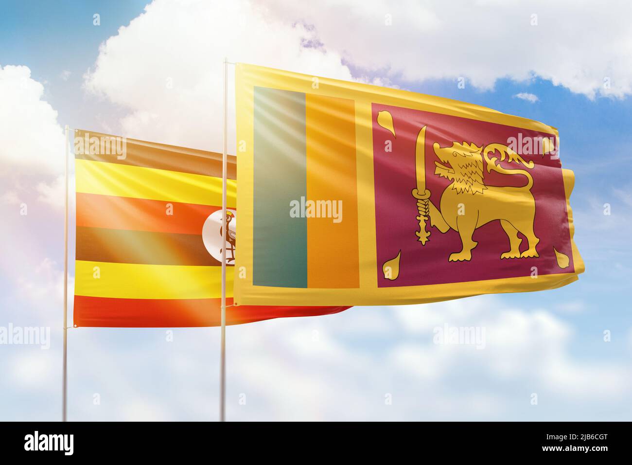 Sunny blue sky and flags of sri lanka and uganda Stock Photo - Alamy