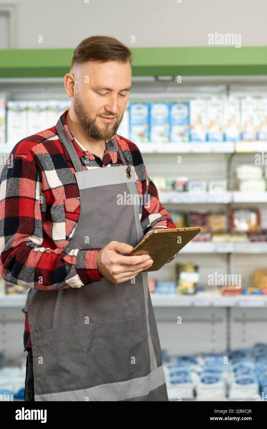 Supermarket employee using wireless hi-res stock photography and images ...