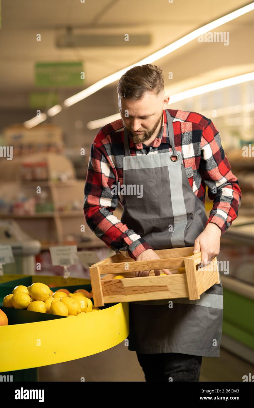 Supermarket shelf worker hi-res stock photography and images - Alamy